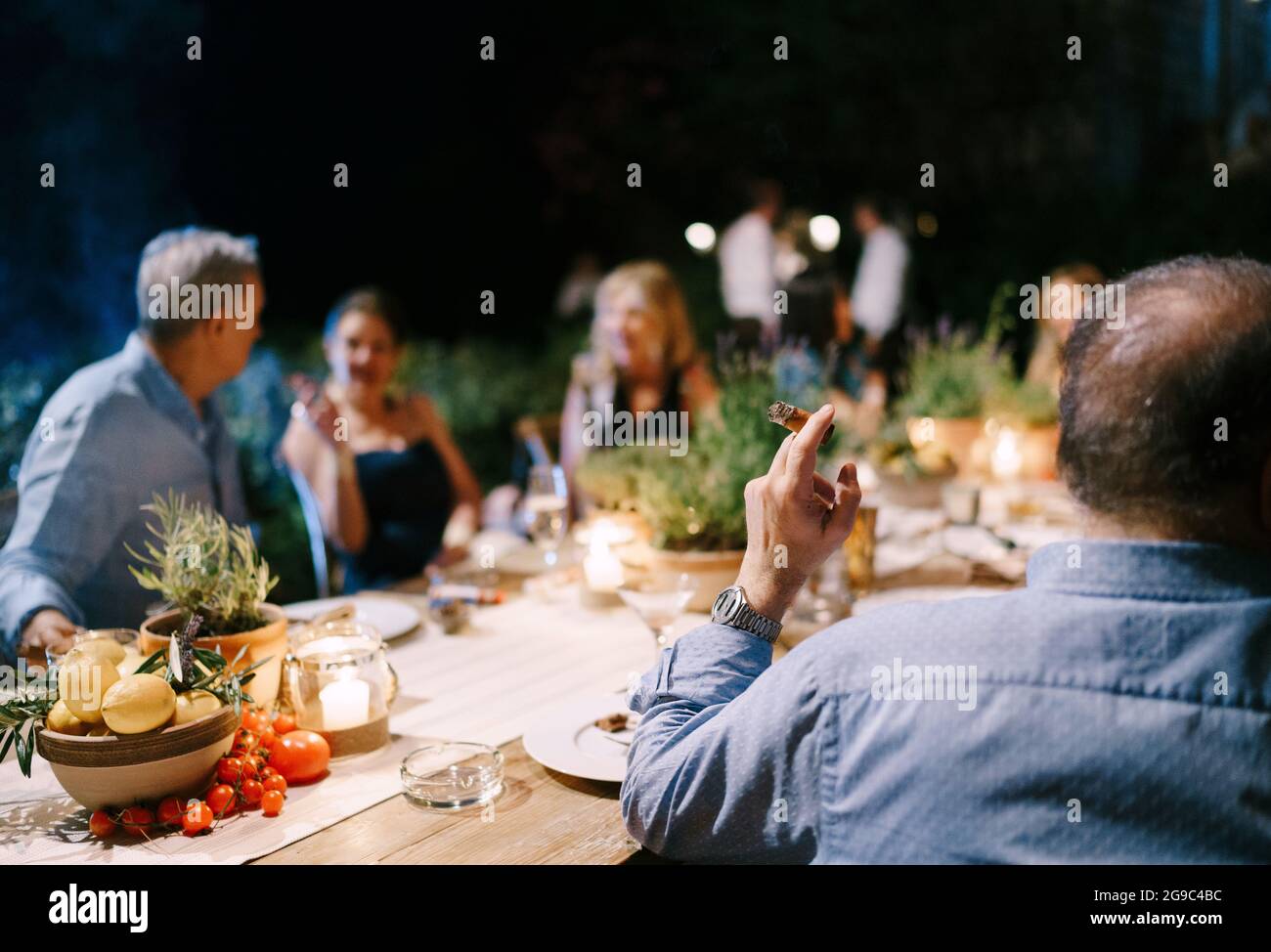 Guests sit at the set table and communicate with each other Stock Photo ...