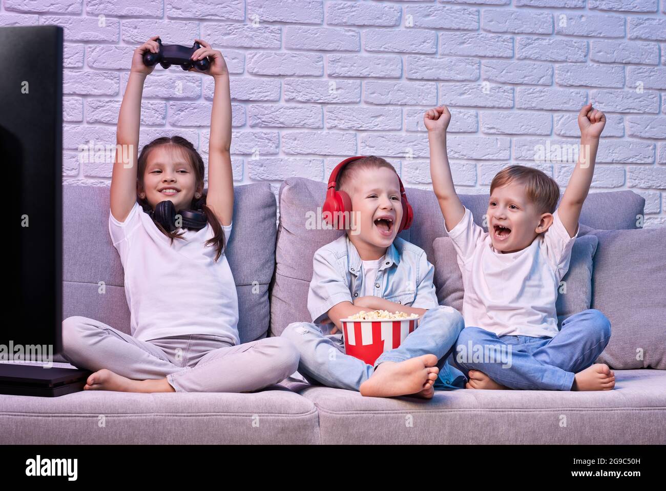 children playing video game with game console Stock Photo - Alamy