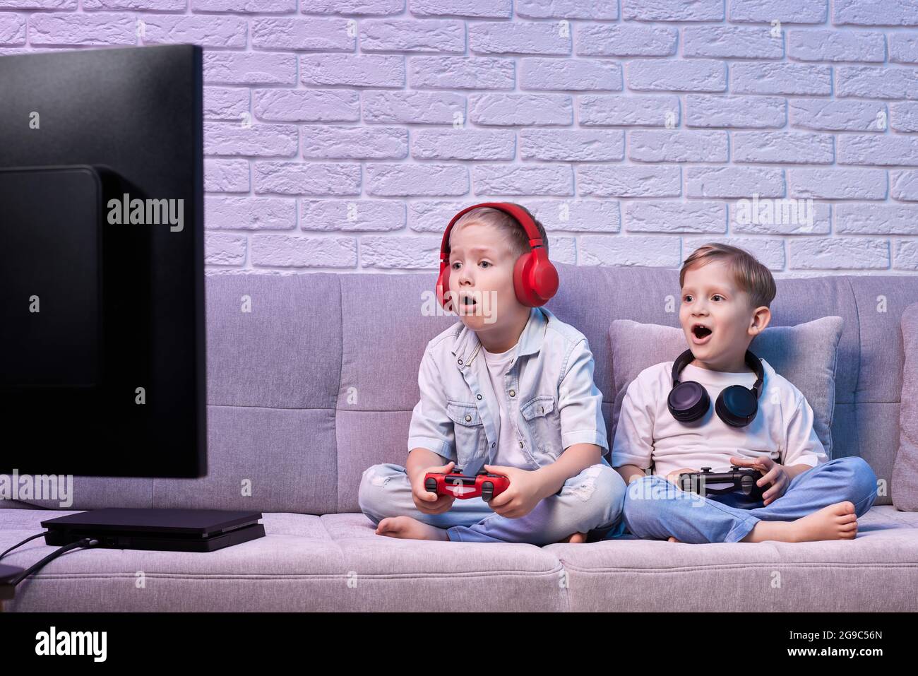 children playing video game with game console Stock Photo - Alamy