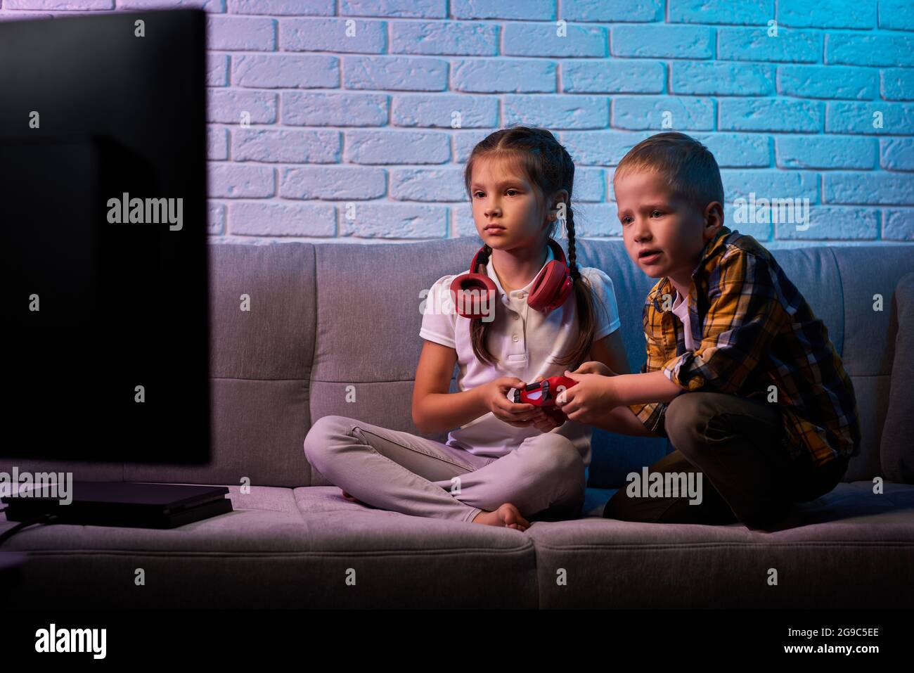 children playing video game with game console Stock Photo - Alamy