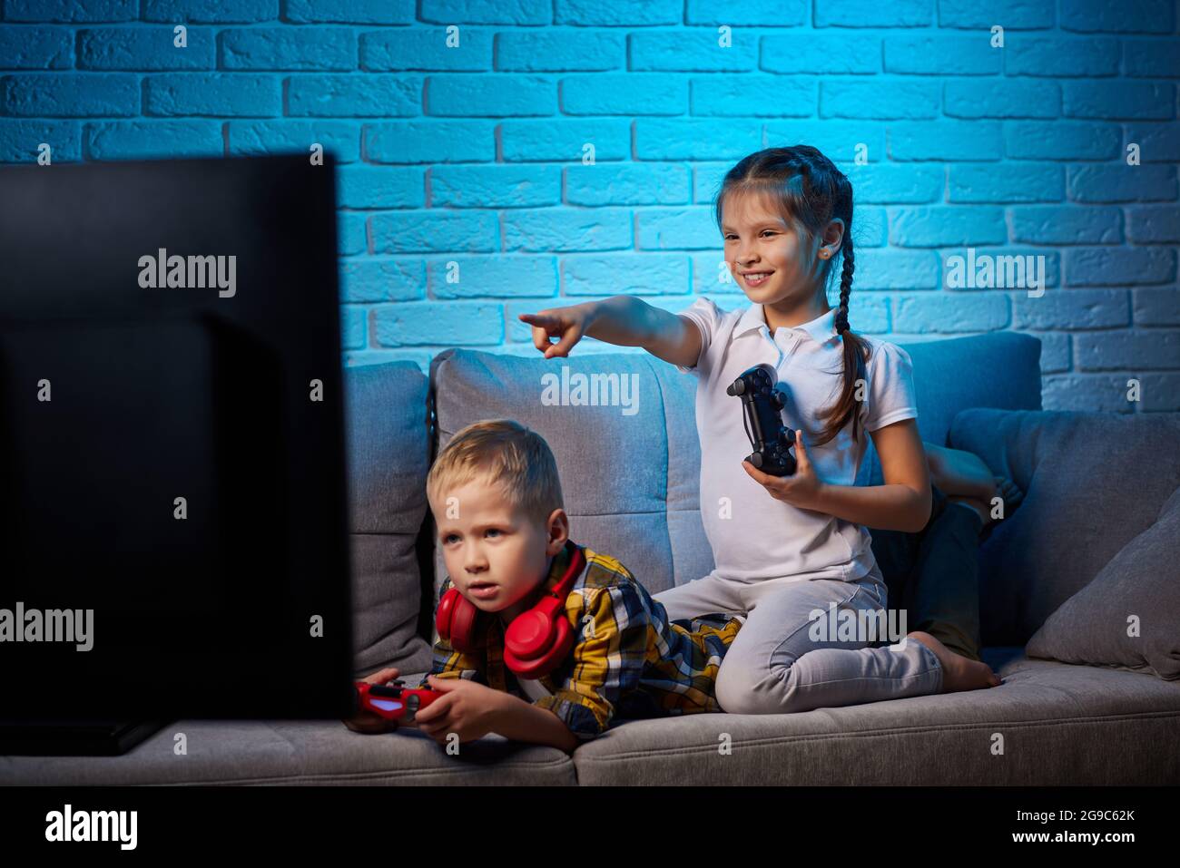 children playing video game with game console Stock Photo - Alamy