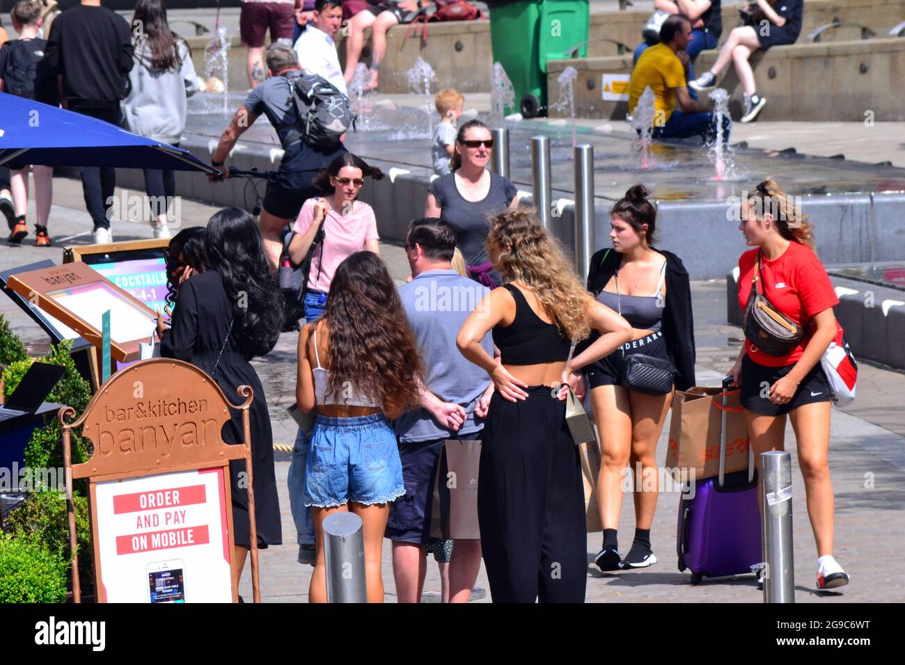 People wait for a table at a restaurant in central Manchester, England ...