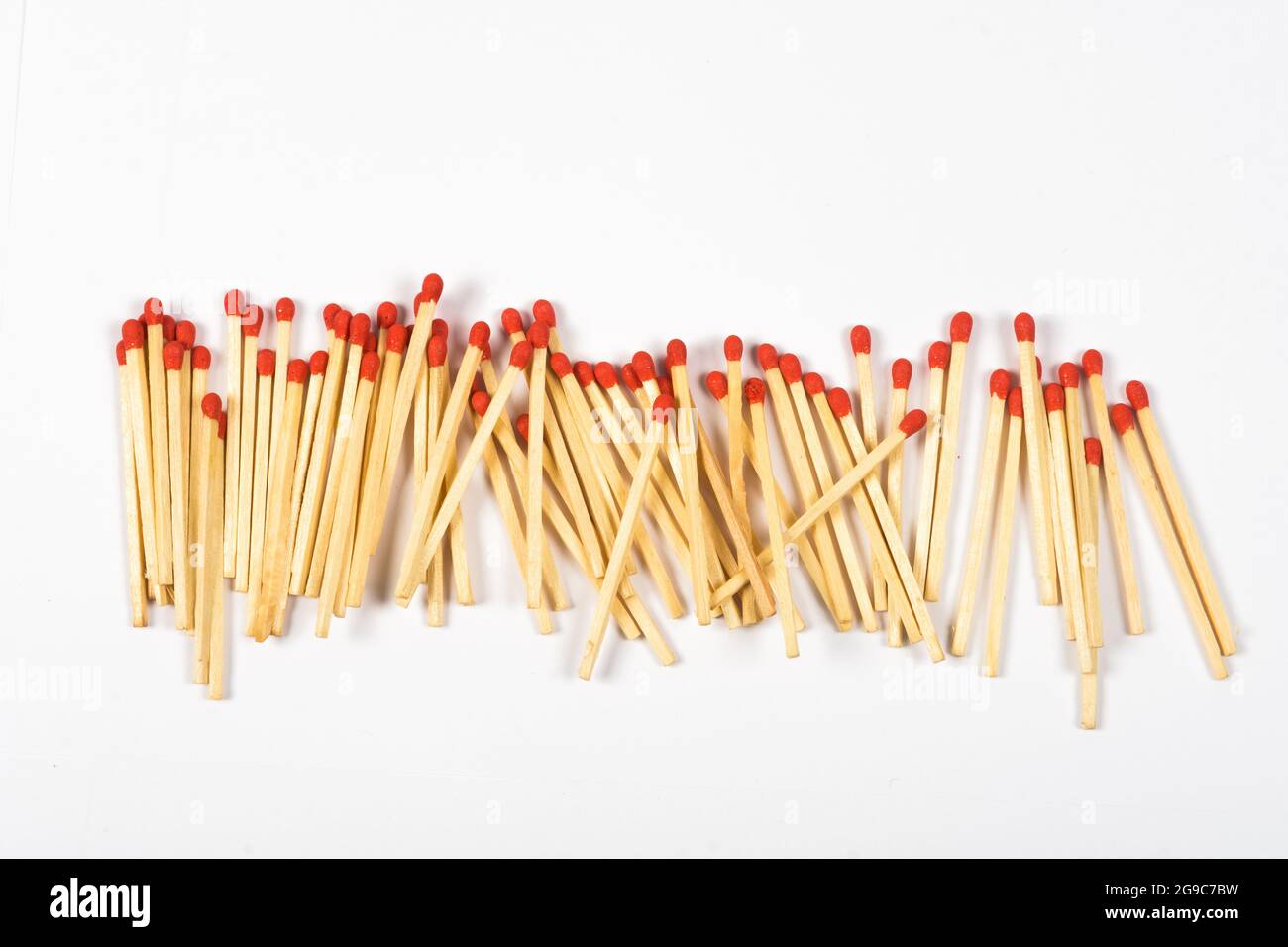 A top view closeup of matches scattered around a white background Stock ...