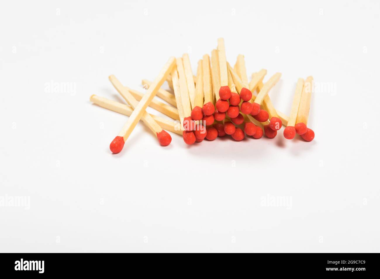 A top view closeup of matches scattered around a white background Stock ...