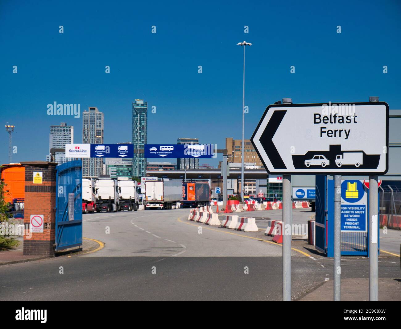 With foreground focus set on the Belfast Ferry sign, lorries queue the ...