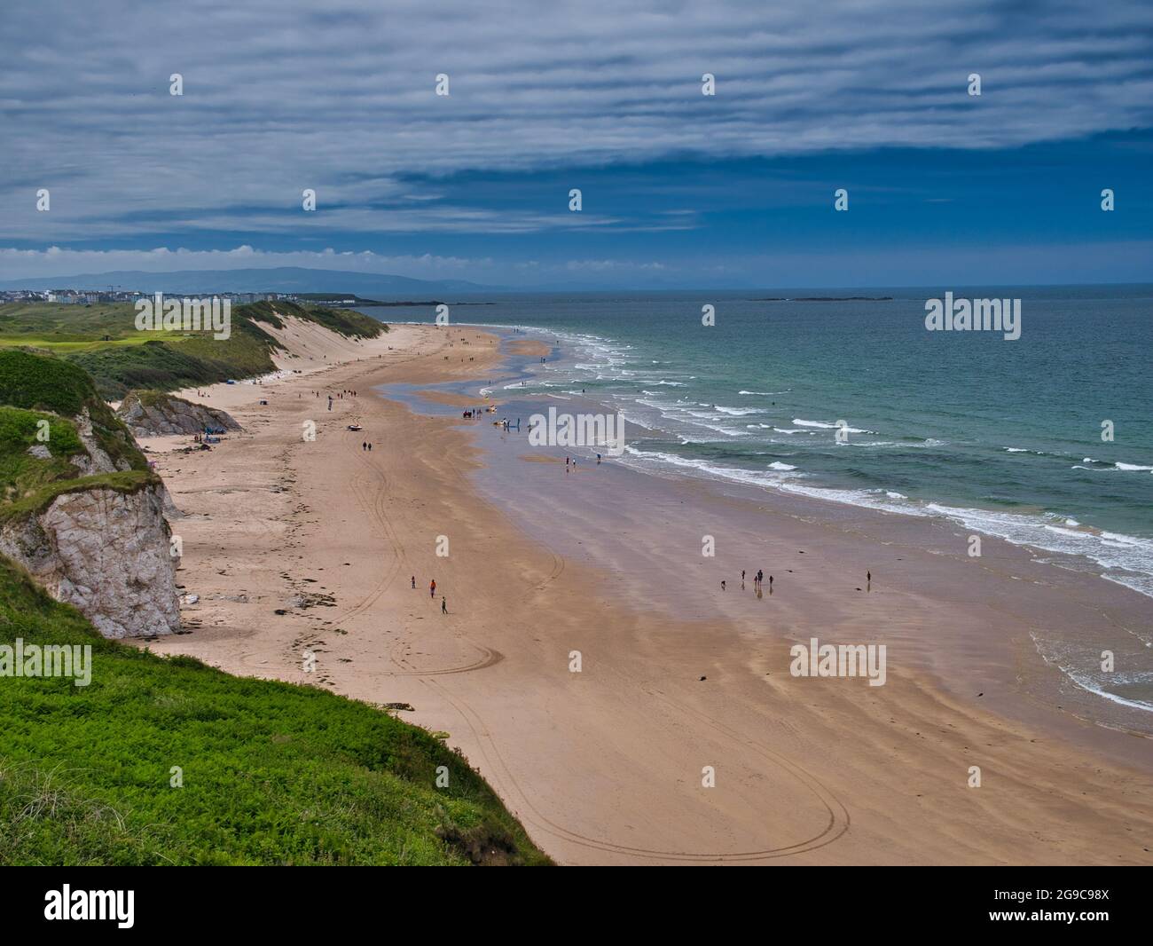 The pristine sand of Whiterocks Beach and coastal cliffs on the Antrim ...