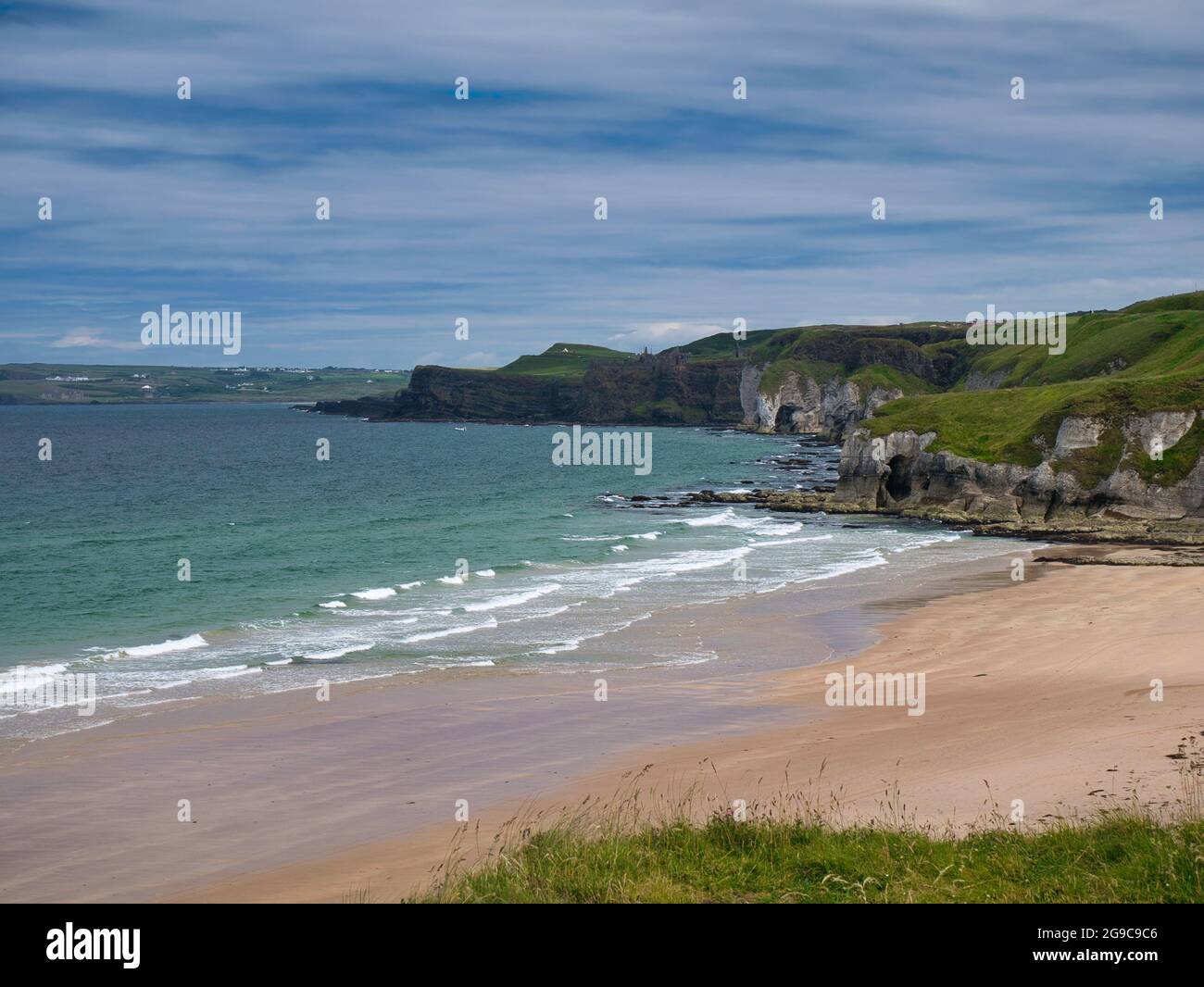 The pristine sand of Whiterocks Beach and coastal cliffs on the Antrim ...