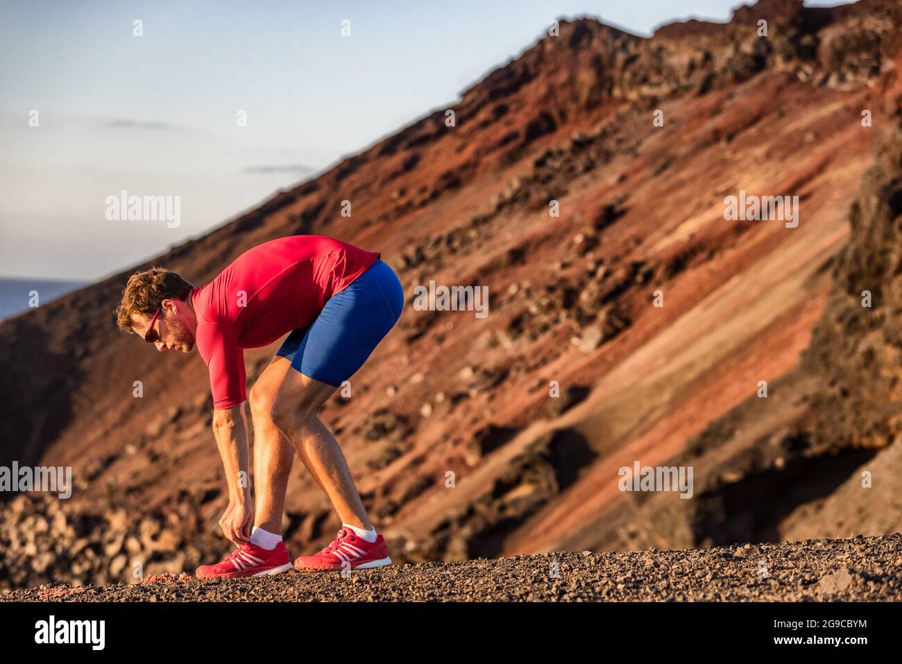 Runner athlete getting ready for training cardio exercise tying running ...