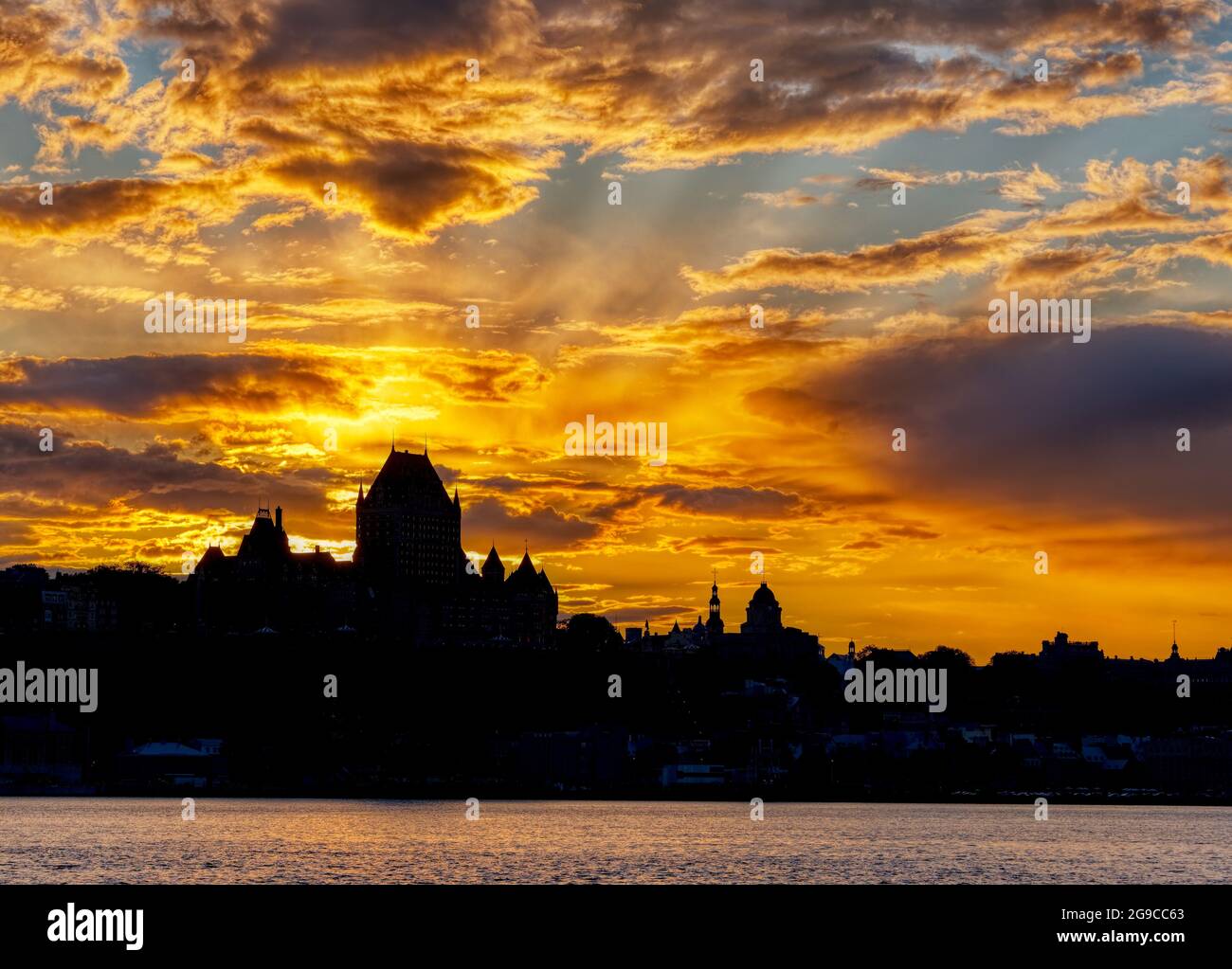 The Quebec City skyline silhouetted against a fiery sunset, as seen ...