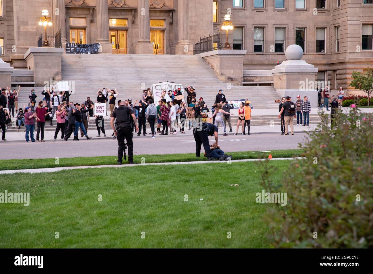 counter protester being arrested after firing his rifle into the ground ...