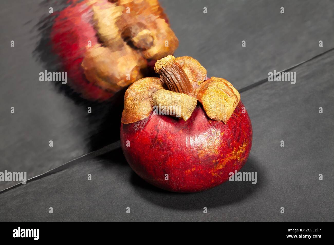 Single mangosteen on red hi-res stock photography and images - Alamy