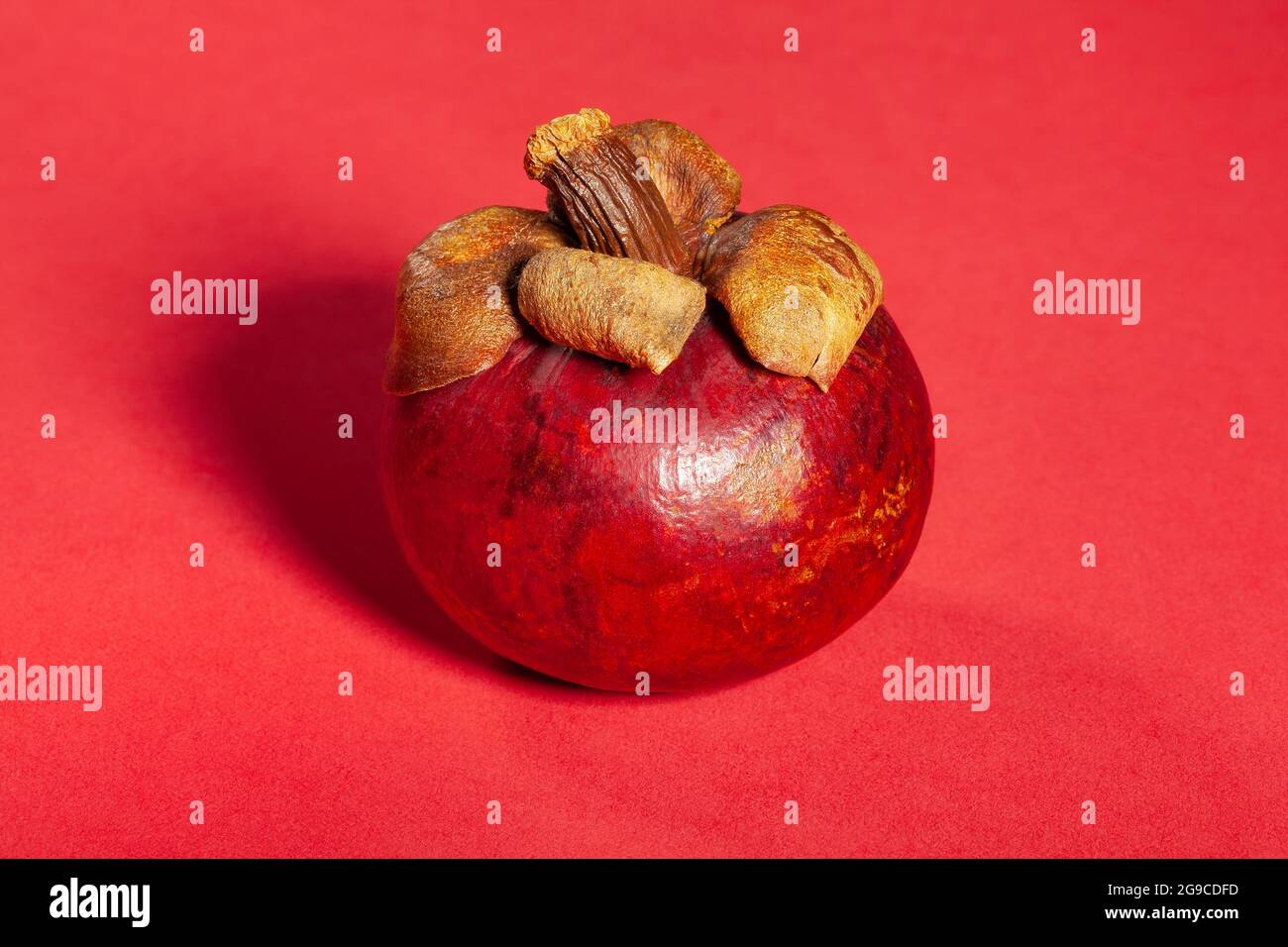 Single mangosteen on red hi-res stock photography and images - Alamy