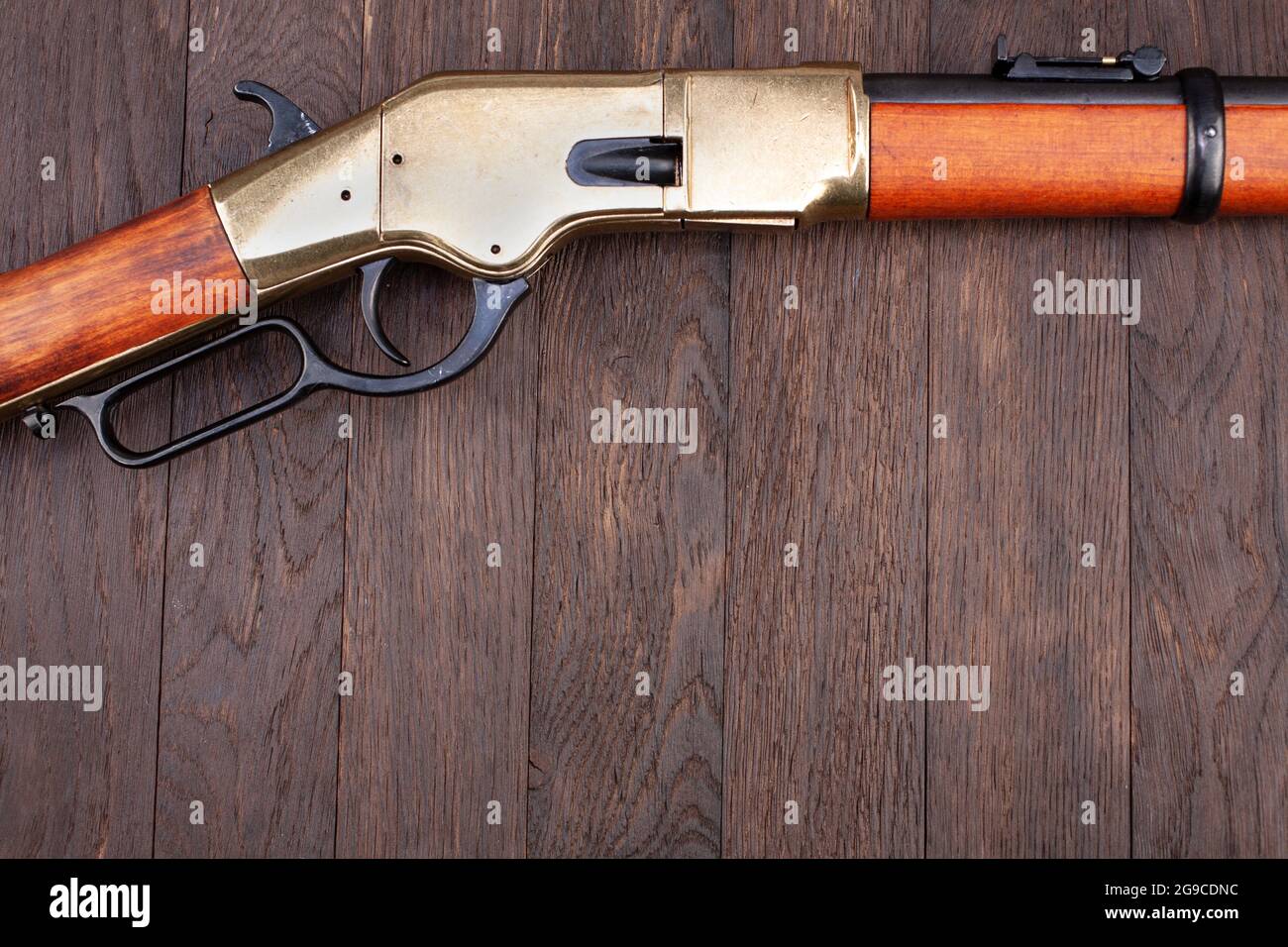 Old west gun - lever-action repeating rifle on wooden table Stock Photo ...