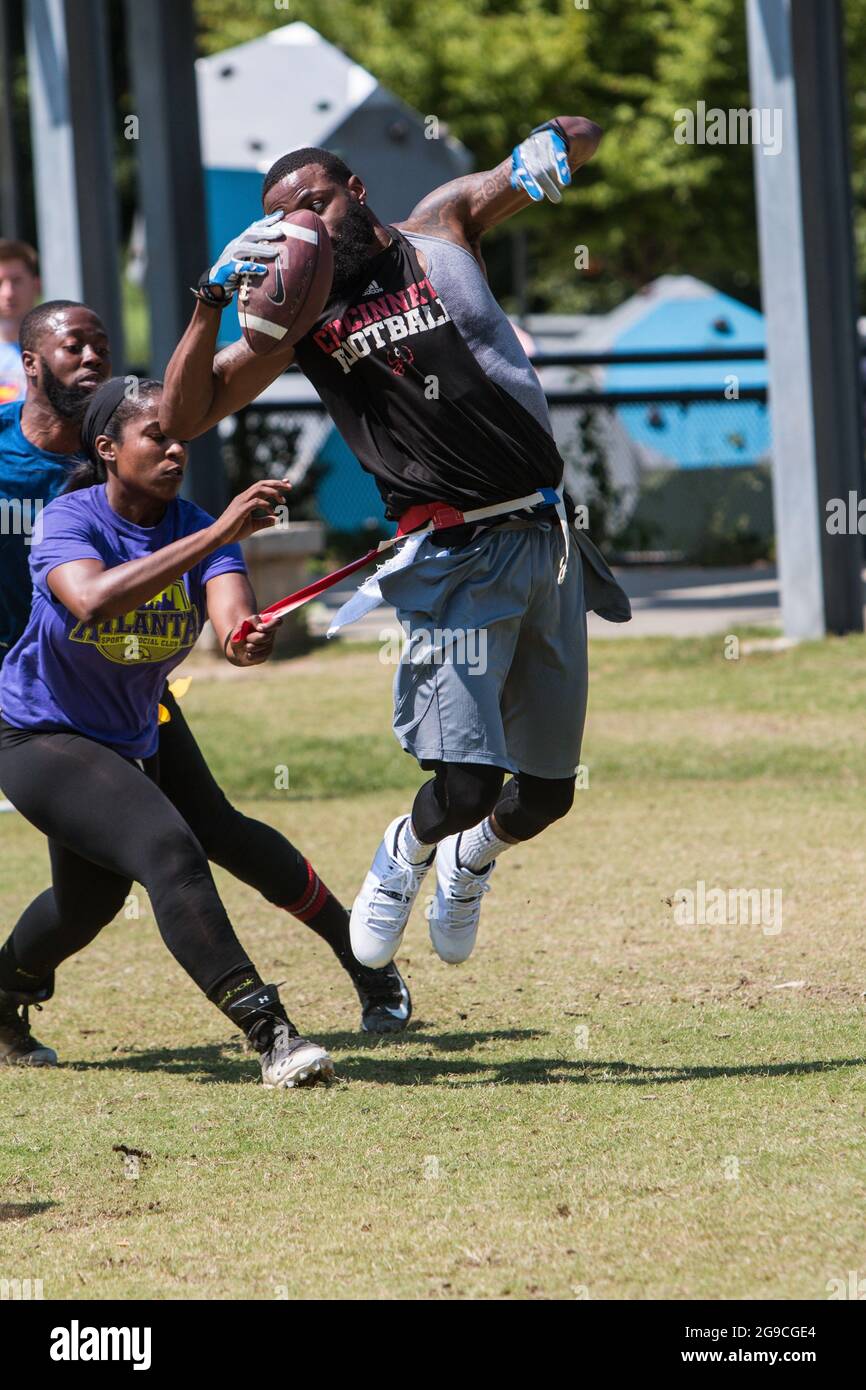 Atlanta, GA, USA - June 1, 2019: A female pulls the flag of a male ...