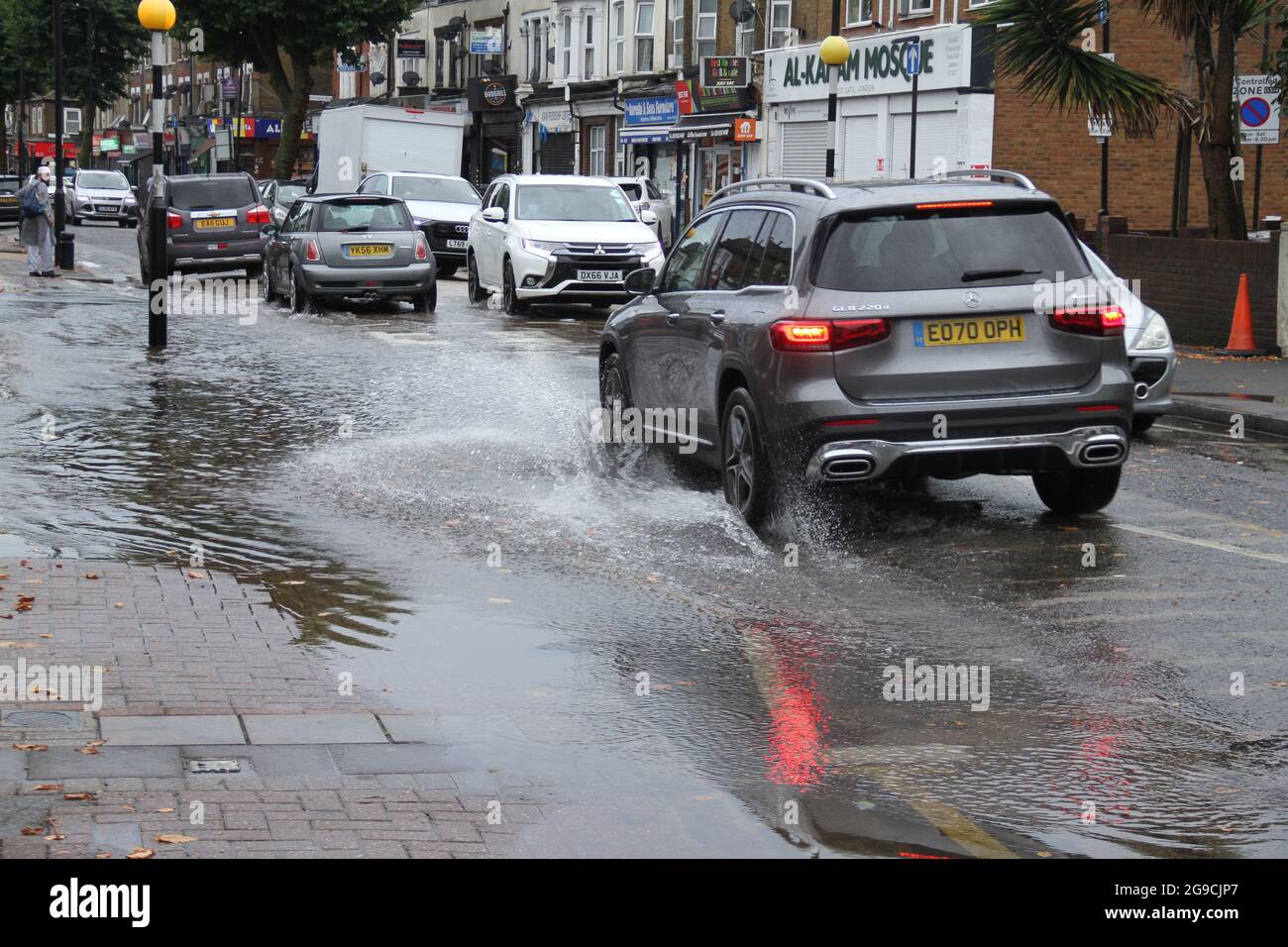Traffic on a waterlogged road in East London following flash floods ...