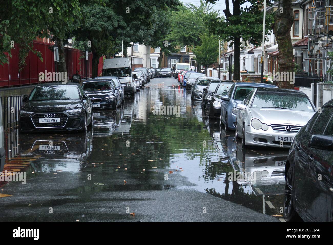 Vehicles seen parked on a flooded street in a suburb in East London ...