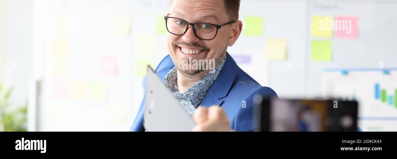 Coach pointing at mobile phone hi-res stock photography and images - Alamy