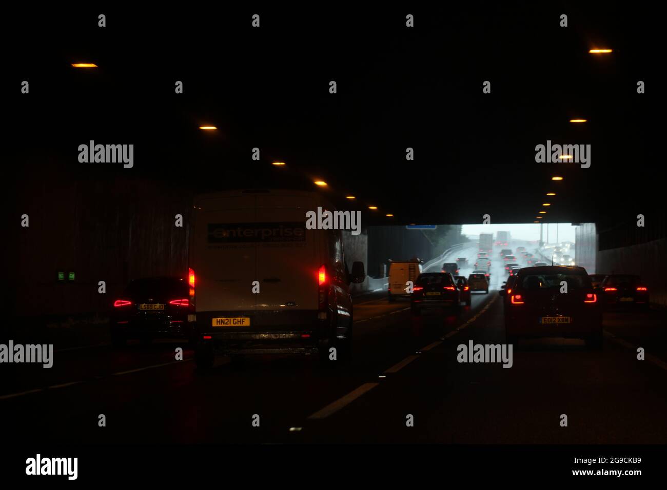 Cars driving towards the exit of a motorway tunnel Stock Photo - Alamy