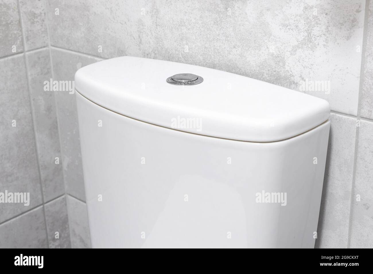 Toilet tank cistern of white ceramic toilet in modern bathroom interior ...