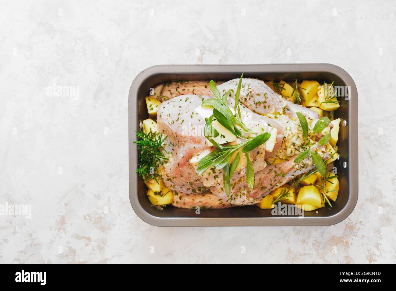 Stuffed turkey brushed with butter. Raw turkey being prepare with fresh ...