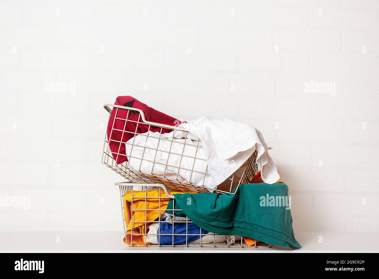 Pile of dirty, colorful laundry in baskets Stock Photo - Alamy