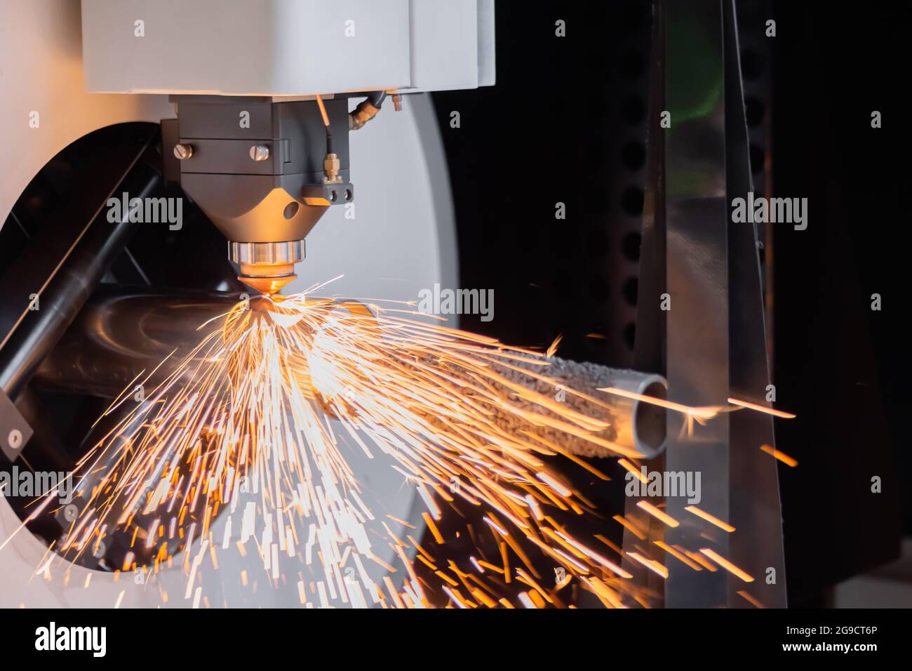 Laser cutting machine working with cylindrical metal workpiece with ...