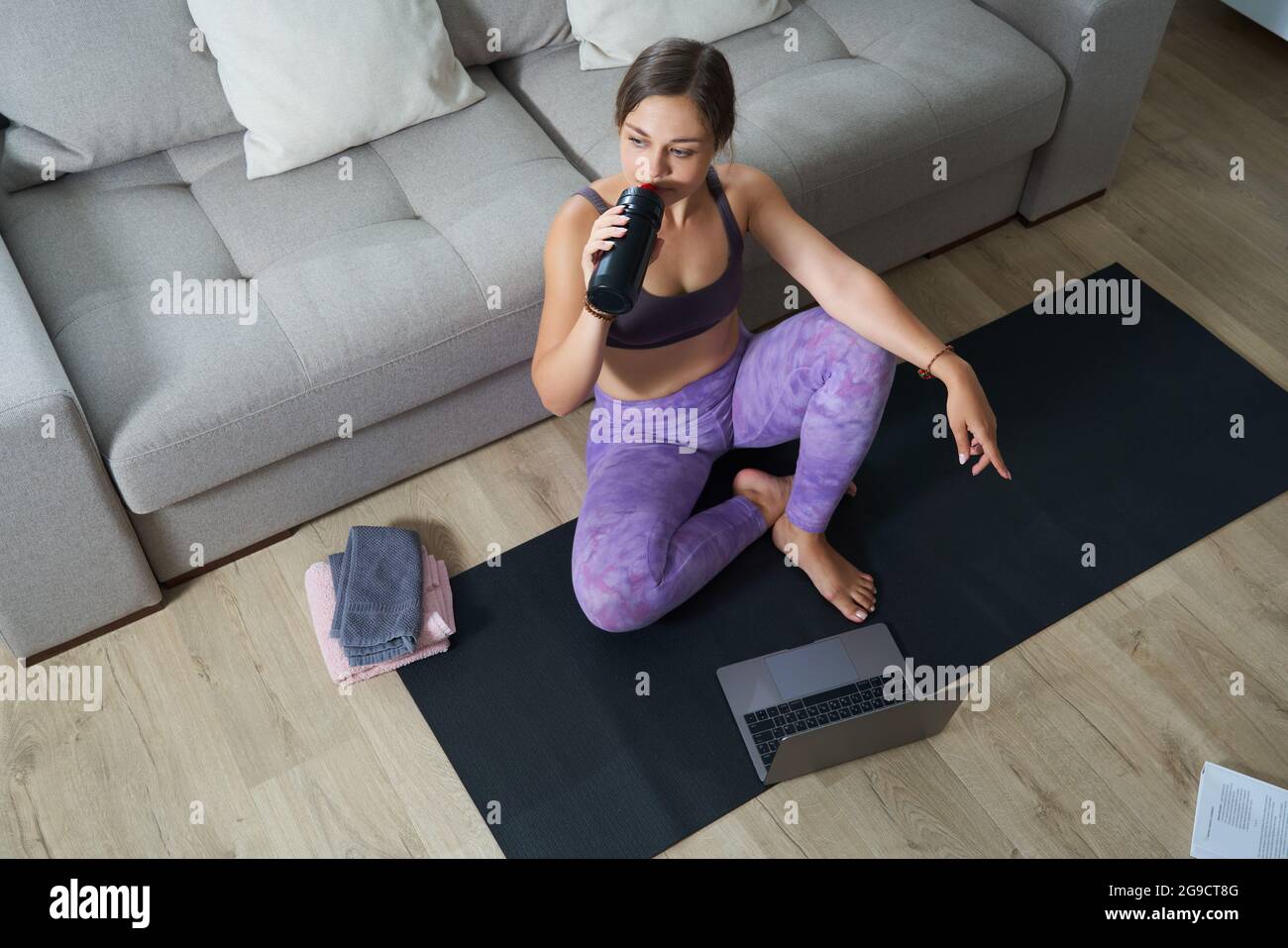 Beautiful Athletic Sporty Woman Sitting On Yoga Mat After Some ...
