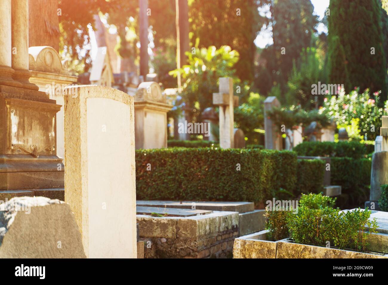 Beautiful European cemetery on sunny day with gravestone in foreground ...