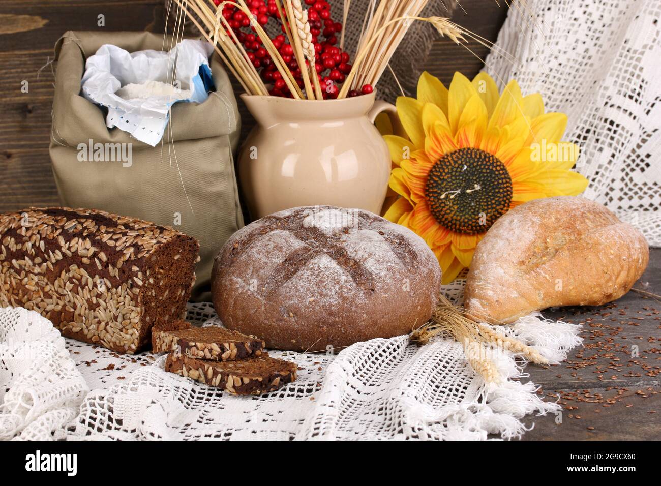 Different types of rye bread on wooden table on autumn composition ...