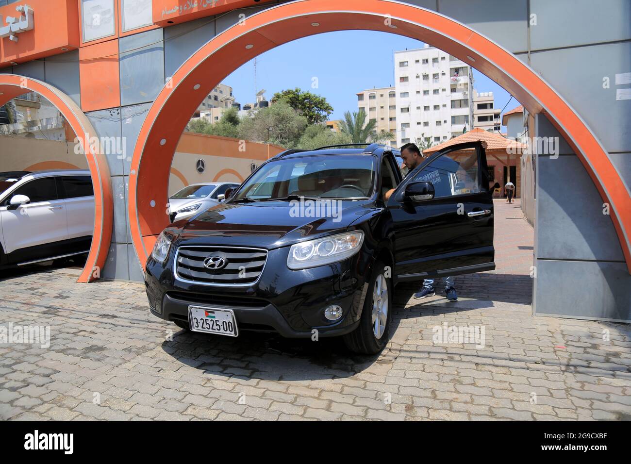 Gaza. 25th July, 2021. A Palestinian man looks at a new car at a car ...