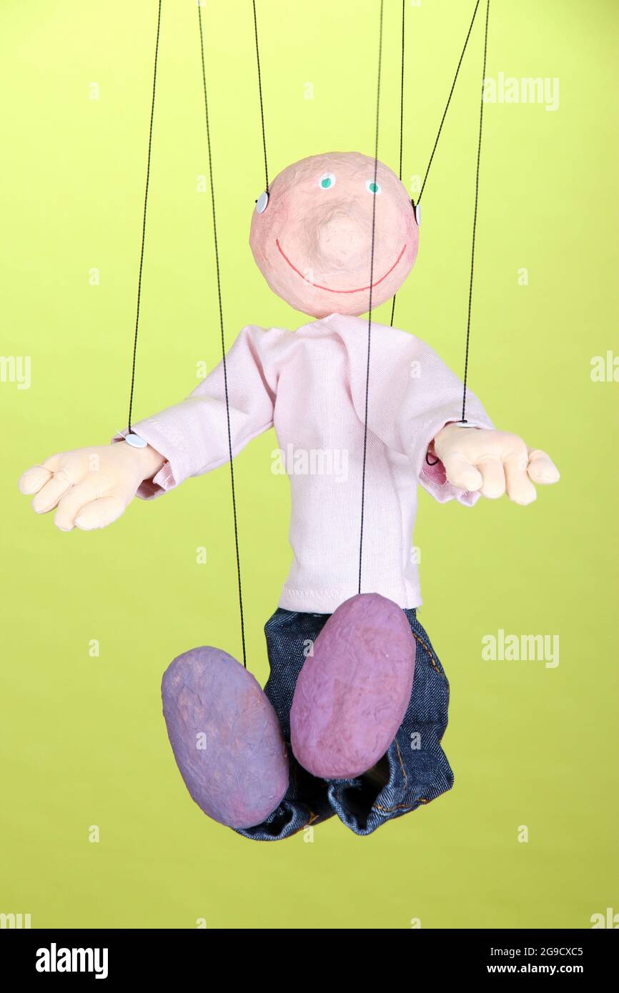Wooden puppet on green background Stock Photo - Alamy