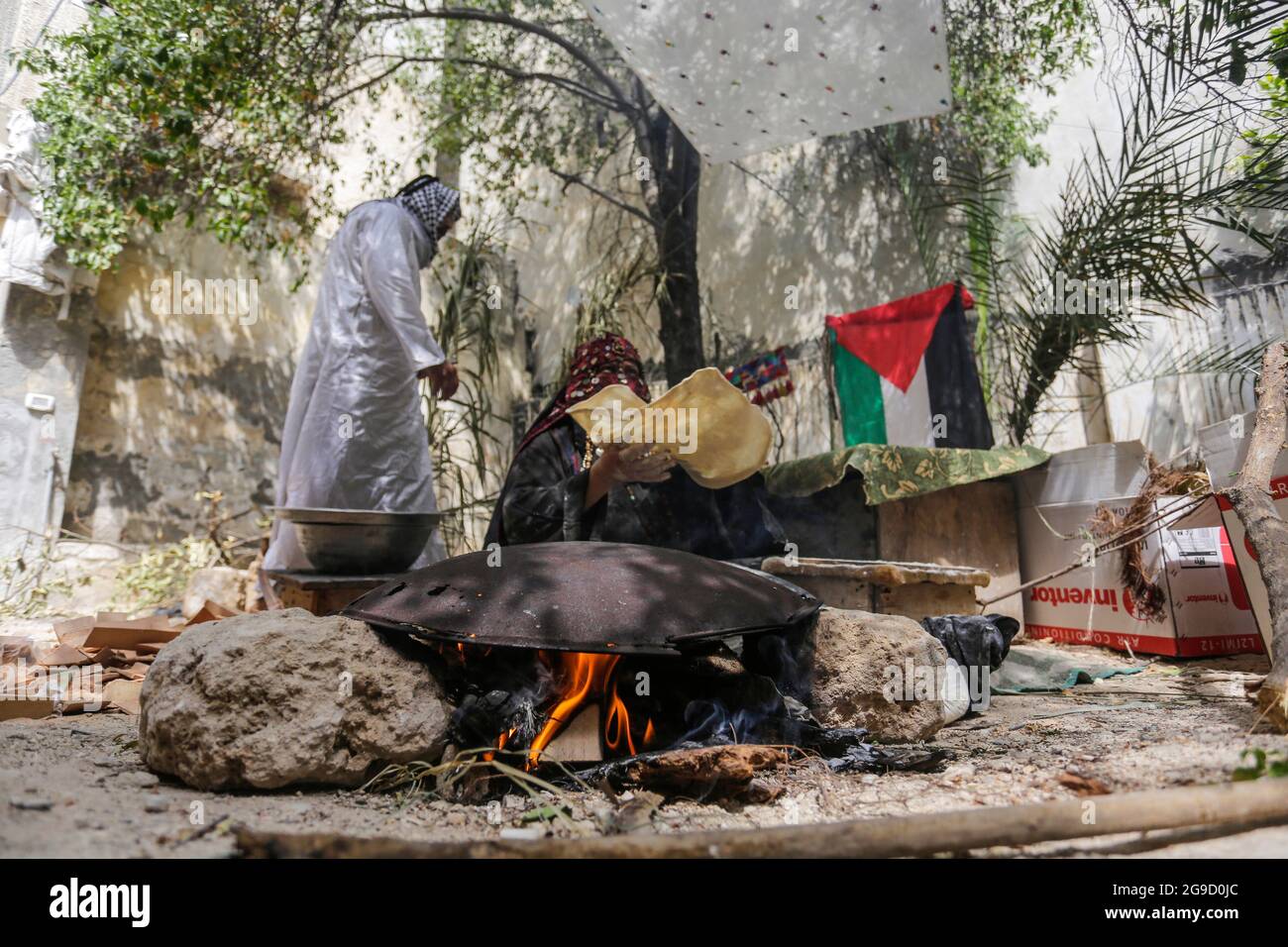 A Palestinian woman bakes Palestinian saj during the exhibition ...