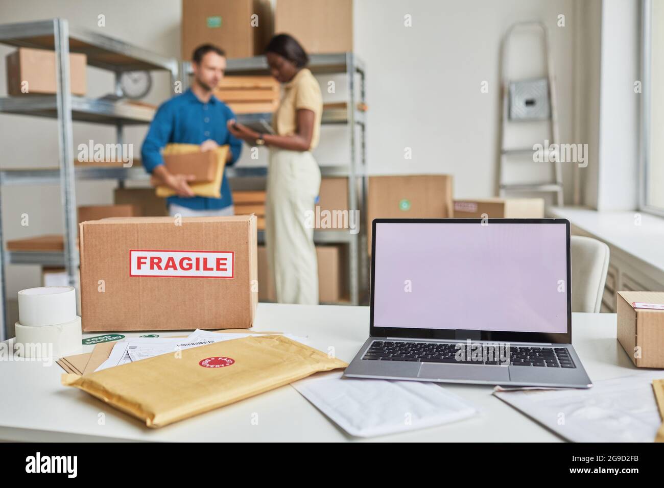 Background image of opened laptop with blank screen in warehouse, small ...