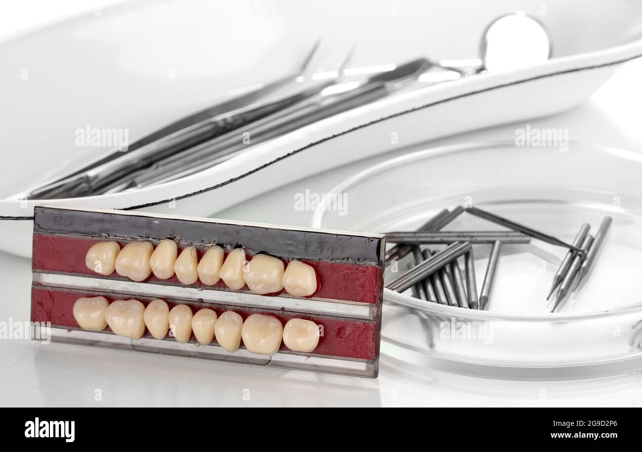 denture with dental tools isolated on white Stock Photo - Alamy