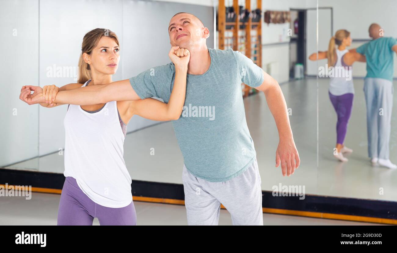 Girl practicing effective self defence techniques in training room ...