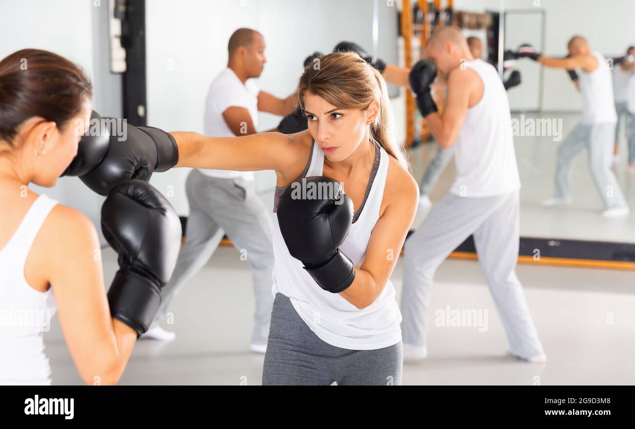 Two women in boxing gloves have boxing fight in the gym Stock Photo - Alamy