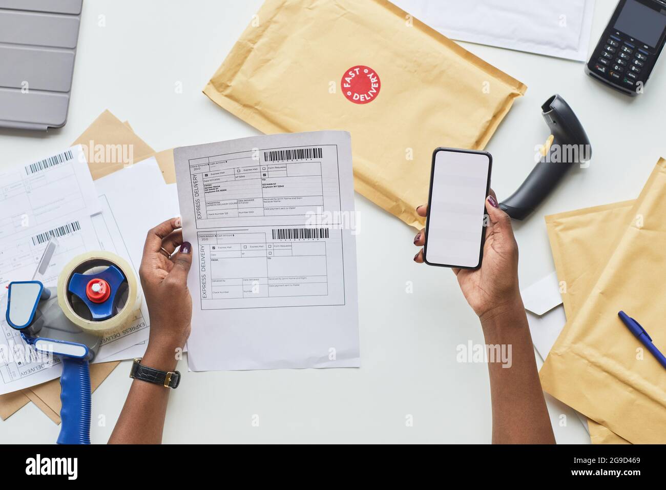 Top down view at female hands holding smartphone with blank screen and ...