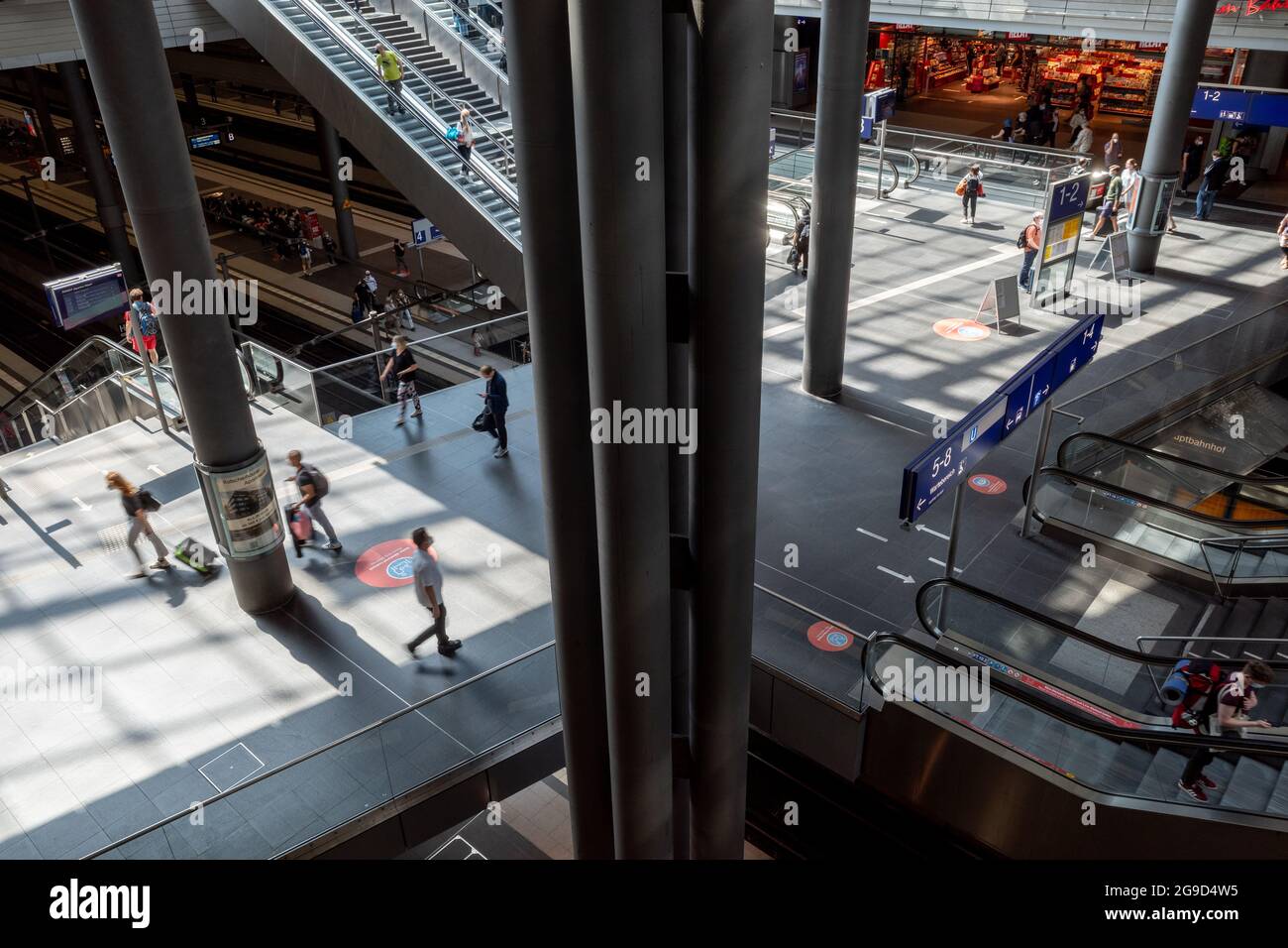 Interior view of platform railway station with escalator, passengers ...