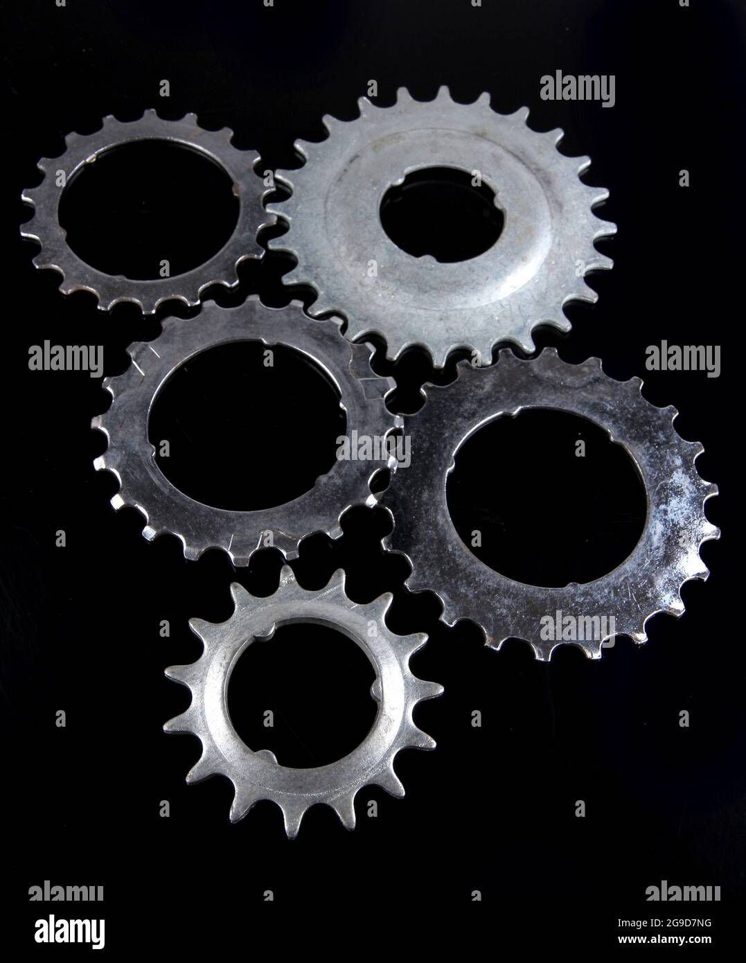 Metal cogwheels on black background Stock Photo - Alamy