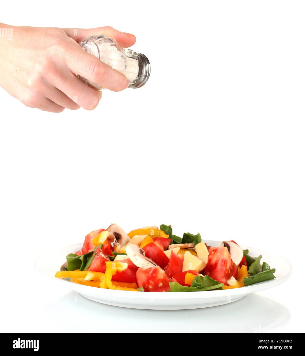 Hand adding salt using salt shaker isolated on white Stock Photo - Alamy