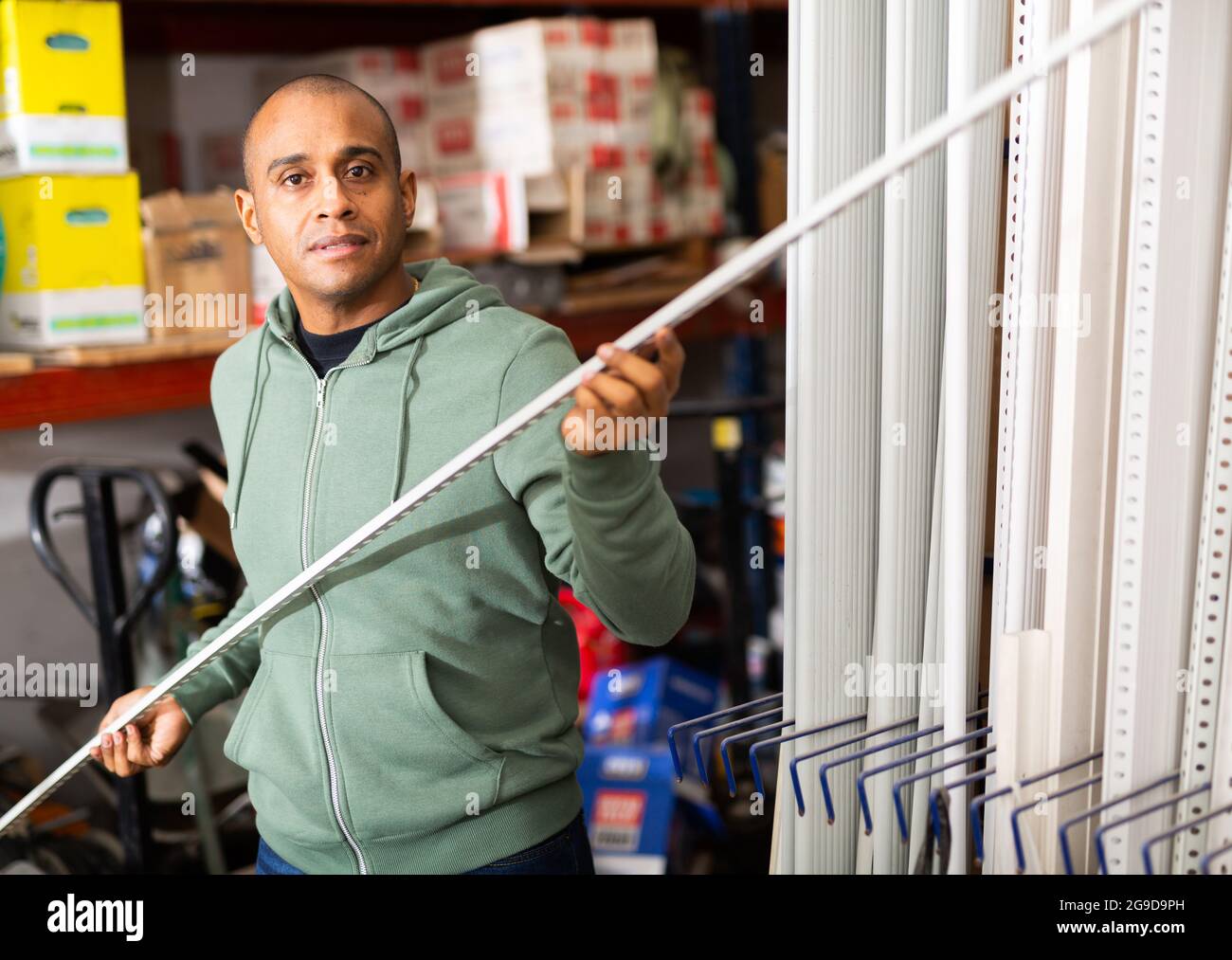Latin american man choosing building materials in store Stock Photo - Alamy