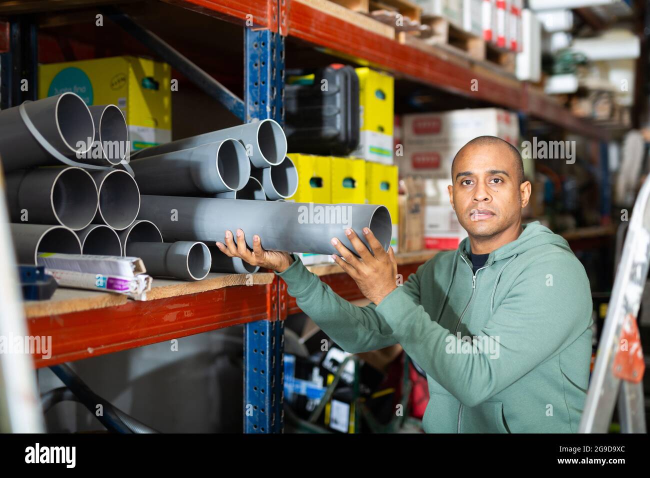Craftsman selects plastic plumbing pipes in hardware store Stock Photo ...