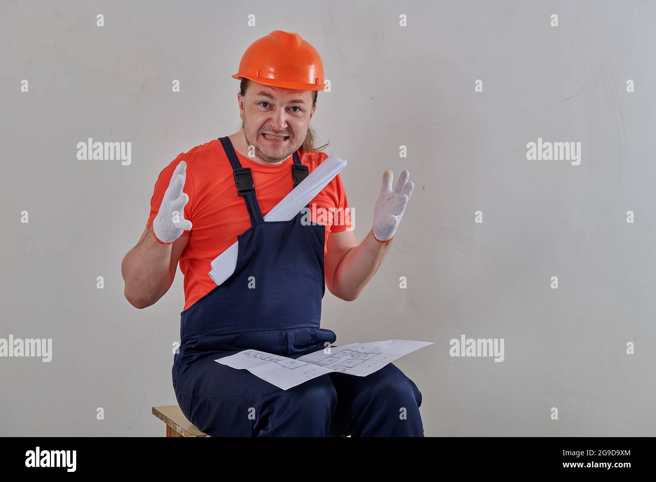 angry foreman shocked by the drawings of the apartment Stock Photo - Alamy
