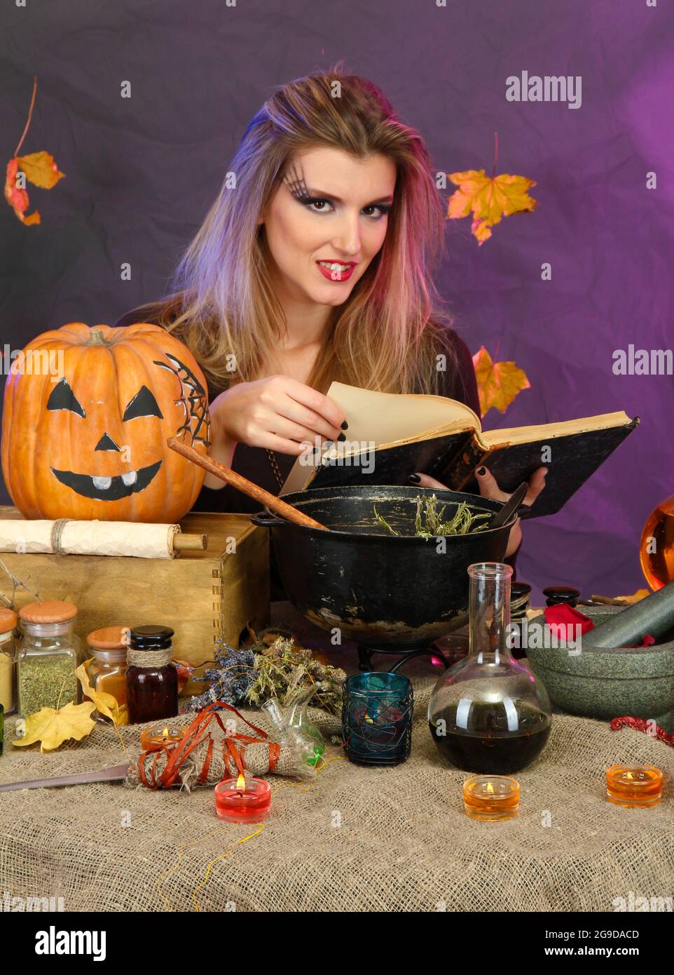 Halloween witch preparing poison soup in her cauldron on color ...