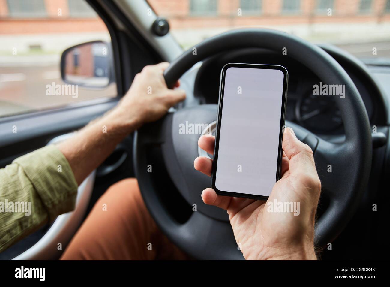 Close up of unrecognizable man driving car focus on hand holding ...