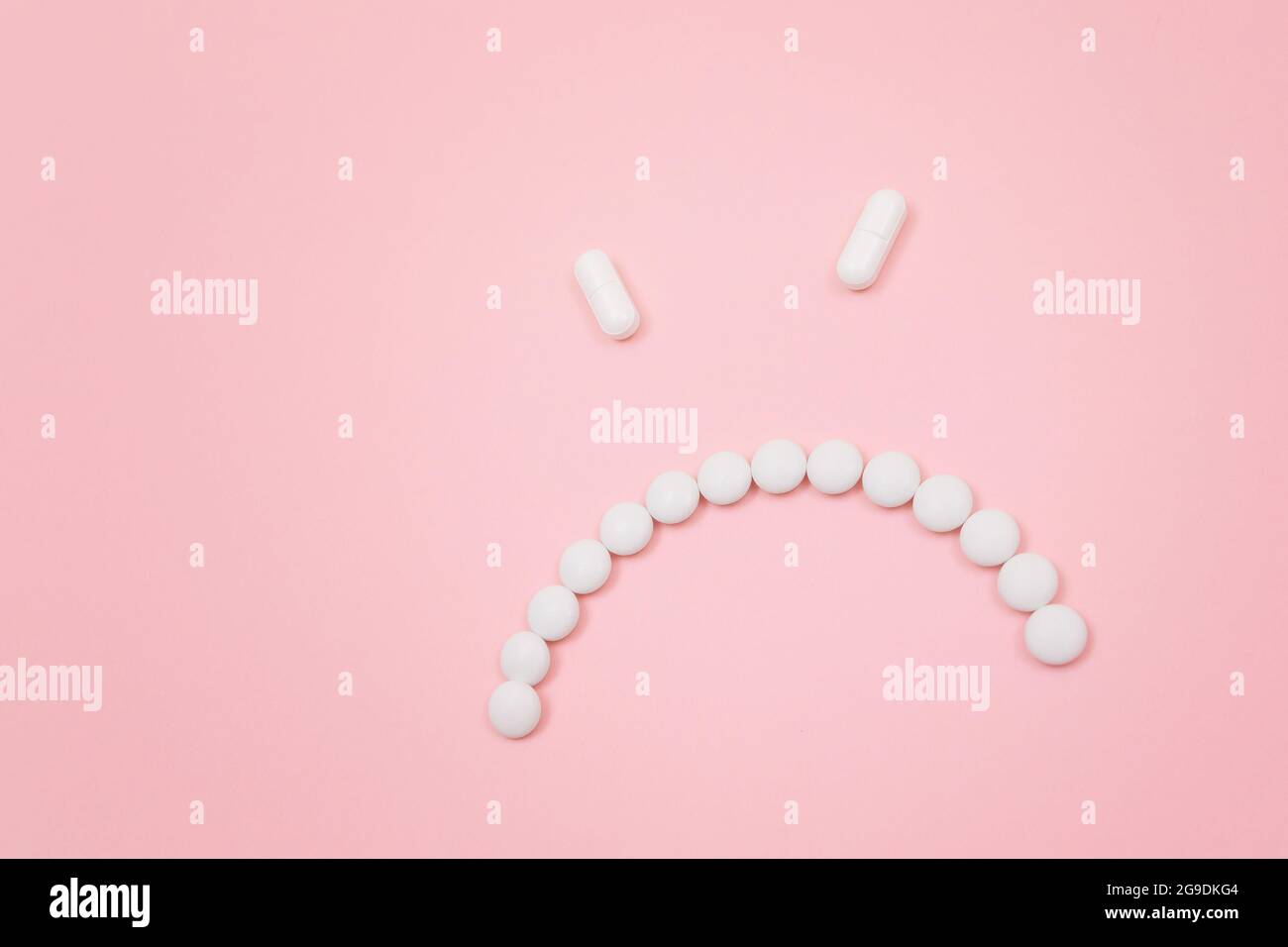 Pharma Harm. Angry Smiley Face Made from White Pills, Lying on Pink ...