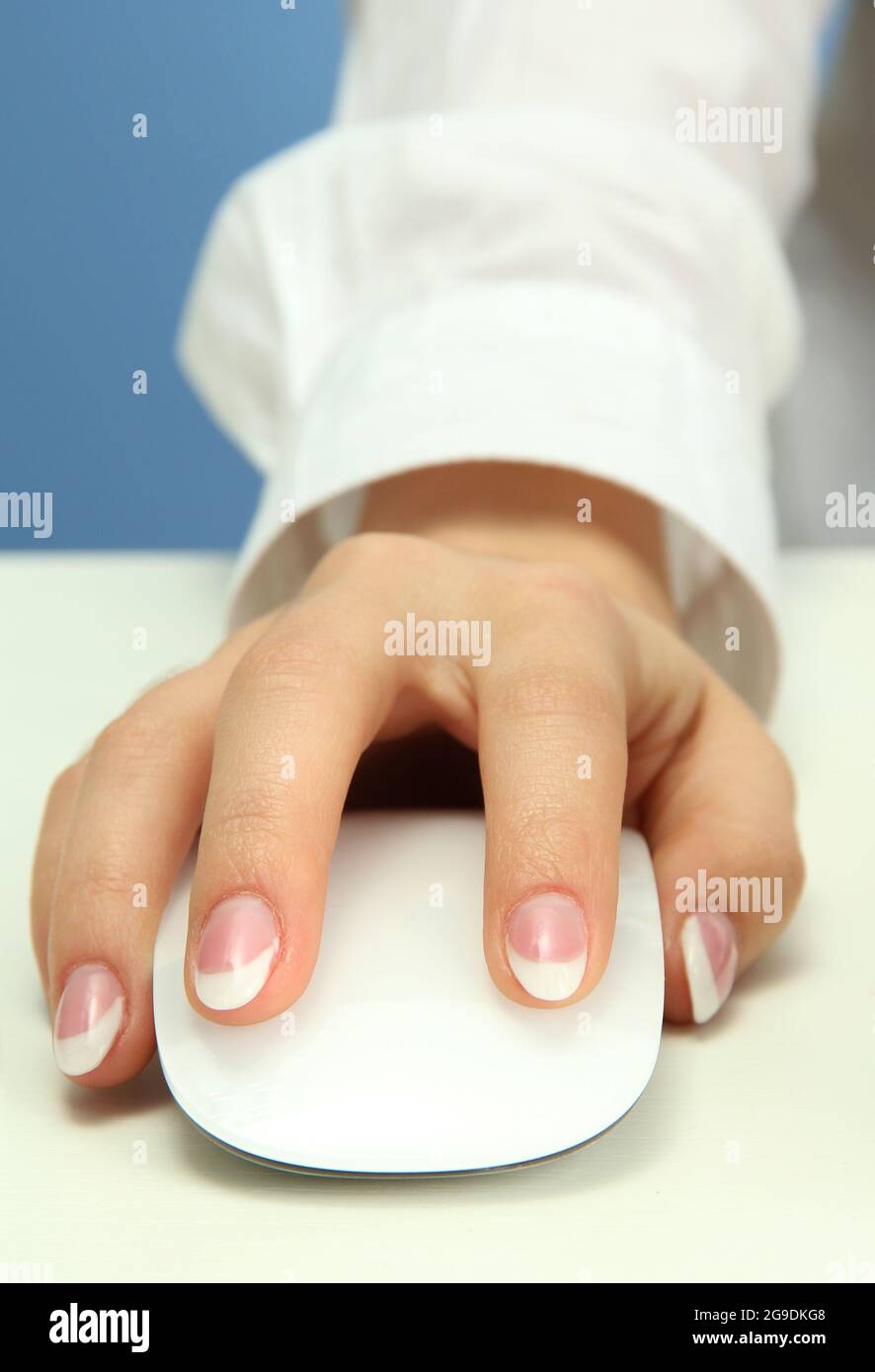 female hand pushing keys of pc mouse, on blue background Stock Photo ...