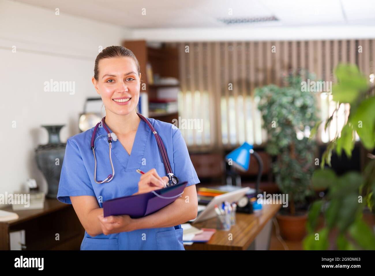 Female doctor assistant standing in medical office Stock Photo - Alamy