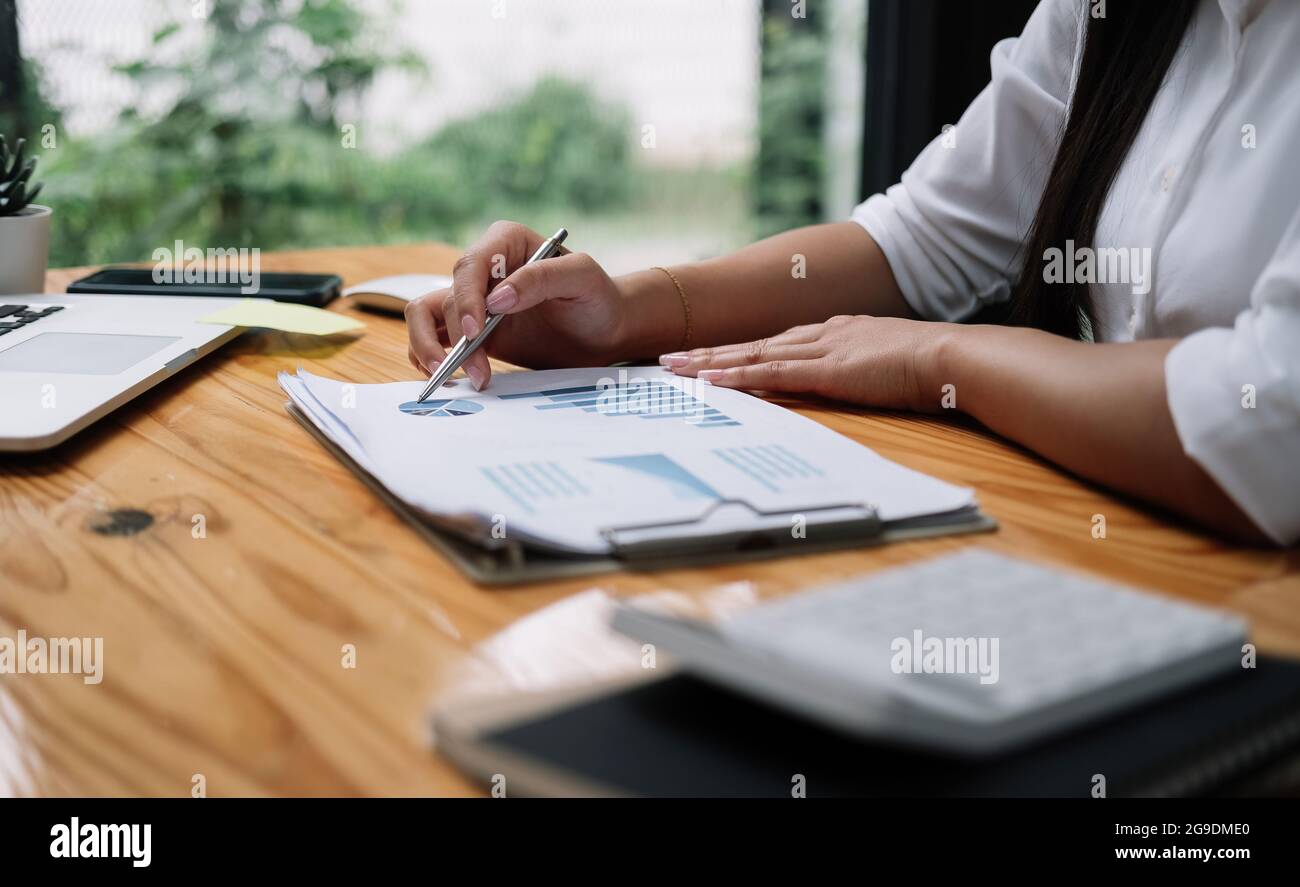 Accountant calculating income expenditure and analyzing investment data ...