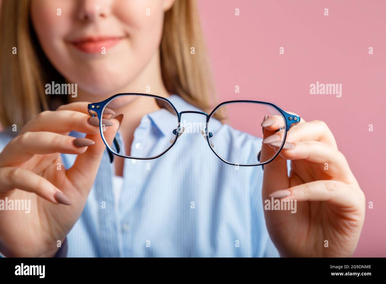Eyeglasses in hands. Blue fashionable metal glasses for vision in ...